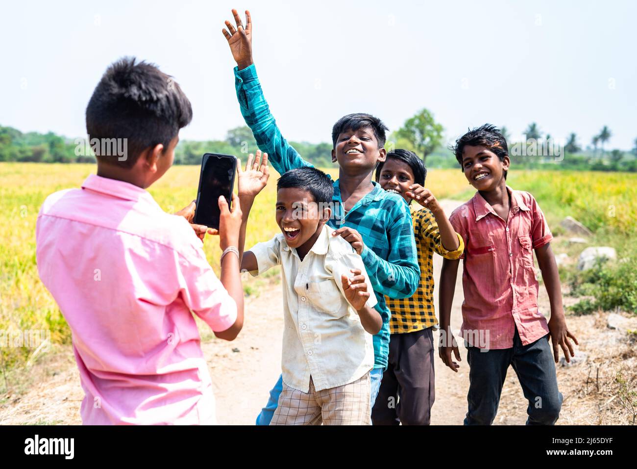 kid making video of his dancing friends for social media in the middle ...