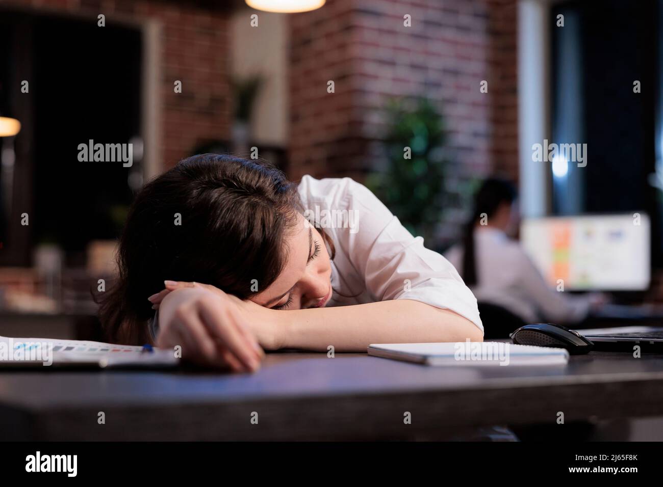 Tired office worker with burnout syndrome sleeping at work because of ...