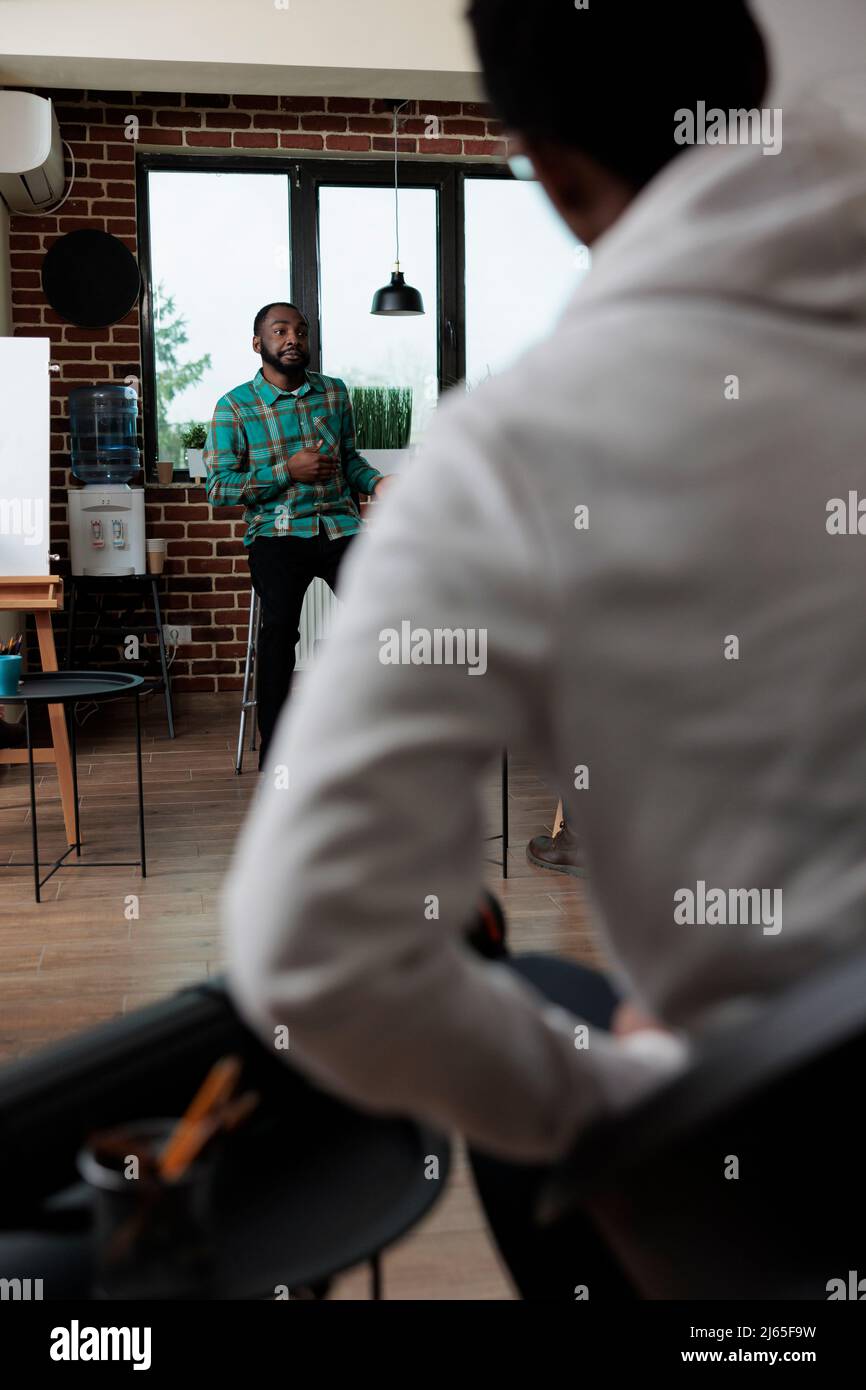 Diverse students attending art lesson learning drawing technique for ...