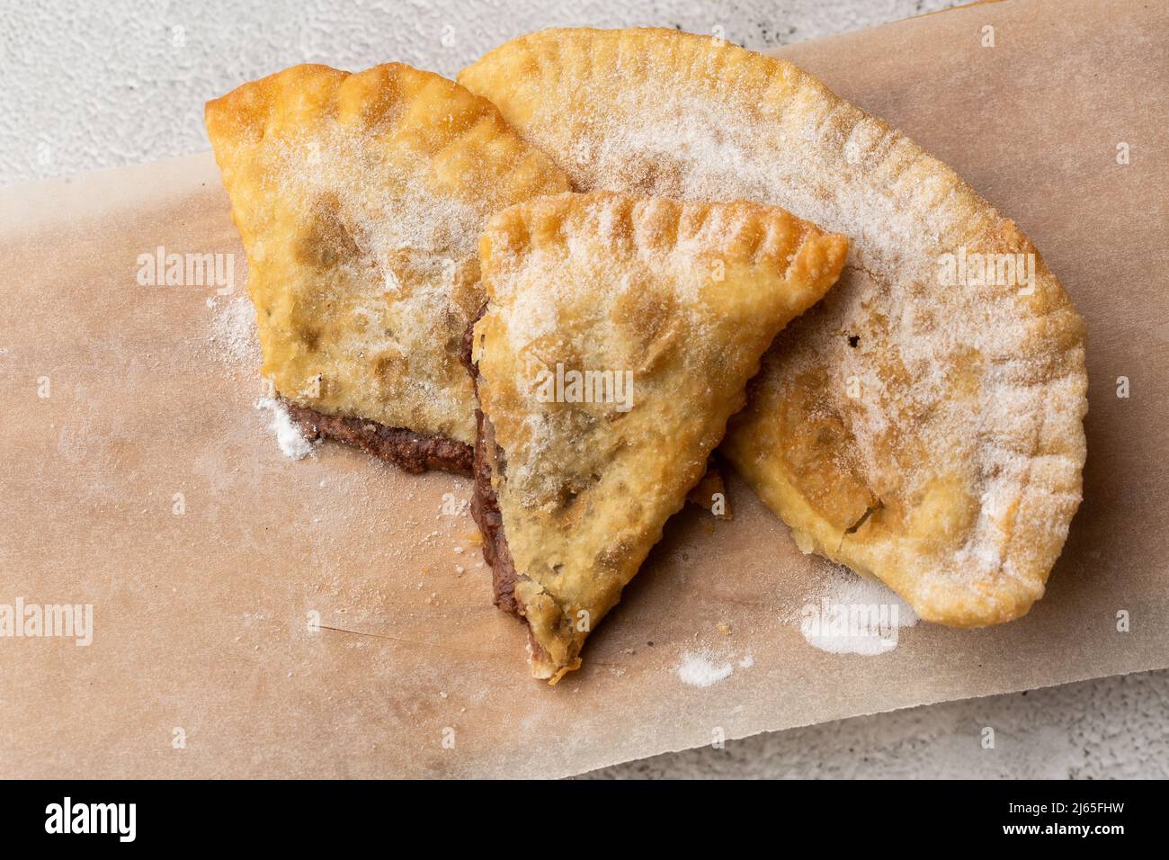 Uzbek eastern Tatar cuisine, sweet cheburek on a wooden board. Cheburek ...