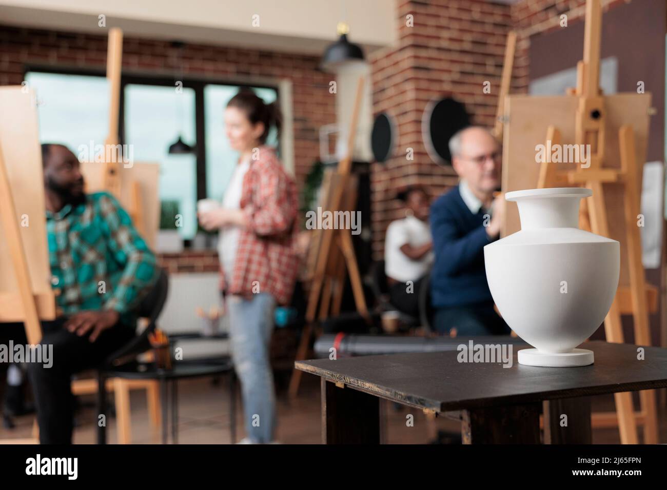 Artist teacher supervising draw class explaining illustration technique ...