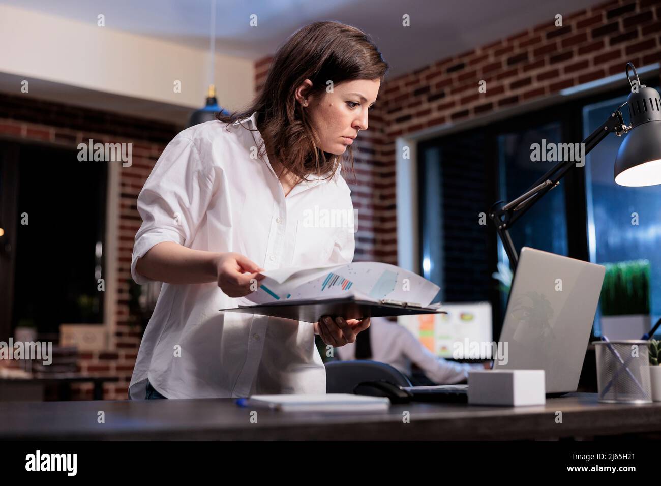 Marketing company employee in office workspace with documentation ... Marketing company employee in office workspace with documentation ...