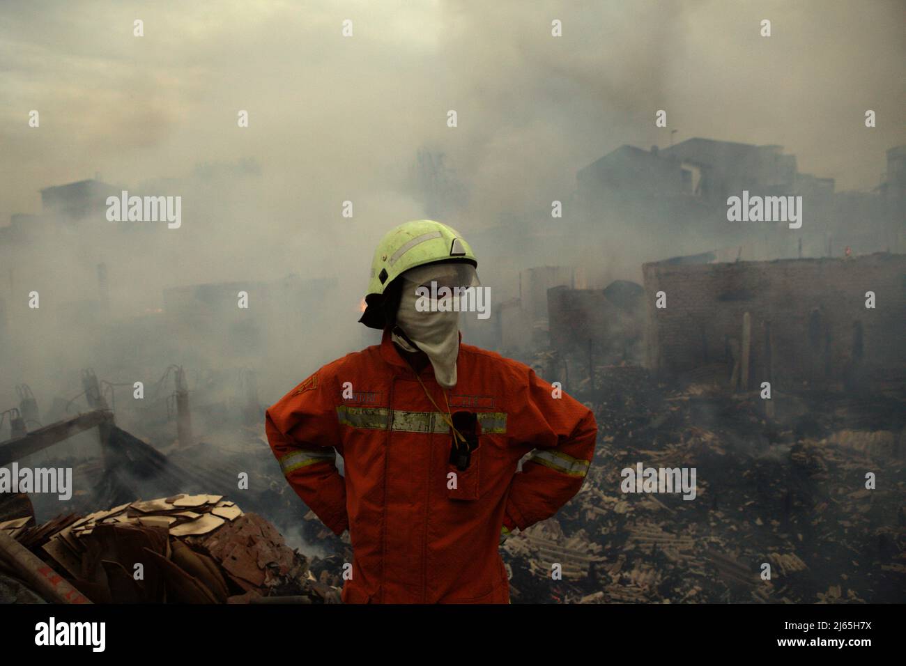 A firefighter taking a break from firefighting after a fire accident ...