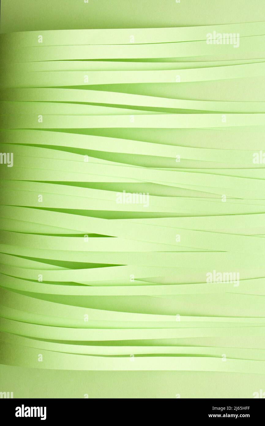 Light green cut paper strips background. Parallel green strips texture ...