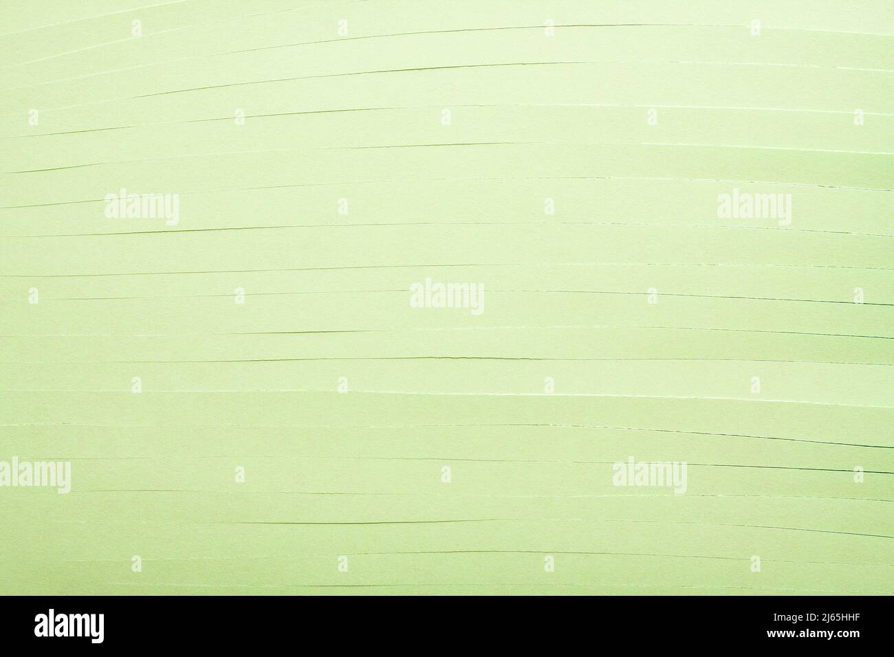 Light green cut paper strips background. Parallel green strips texture ...