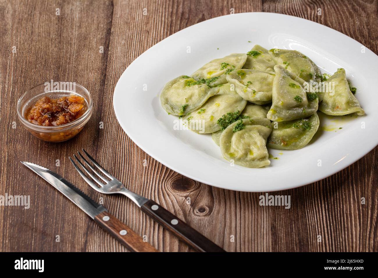 Traditional ukrainian dish vareniki served in a bowl with greaves and ...