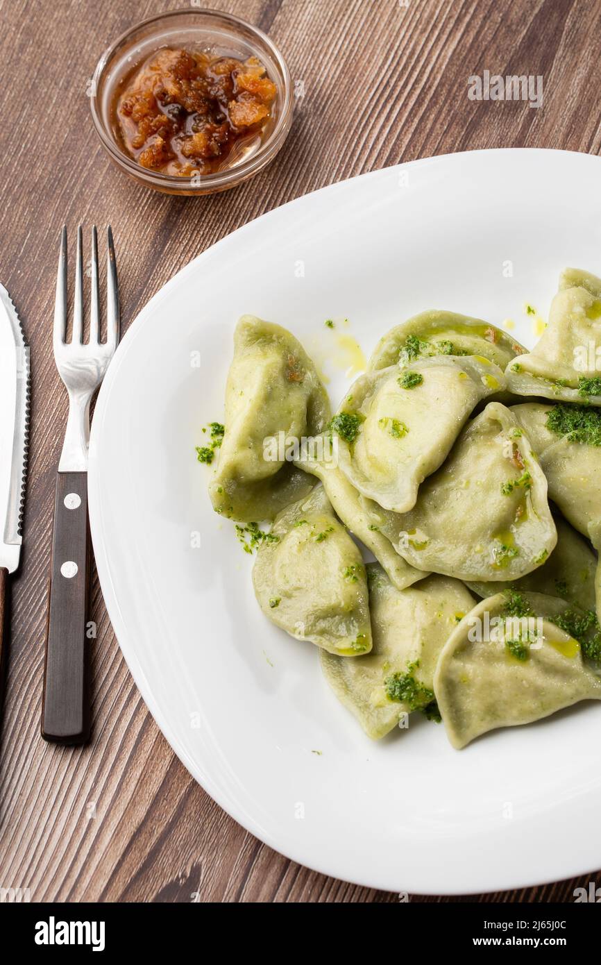 Traditional ukrainian dish vareniki served in a bowl with greaves and ...