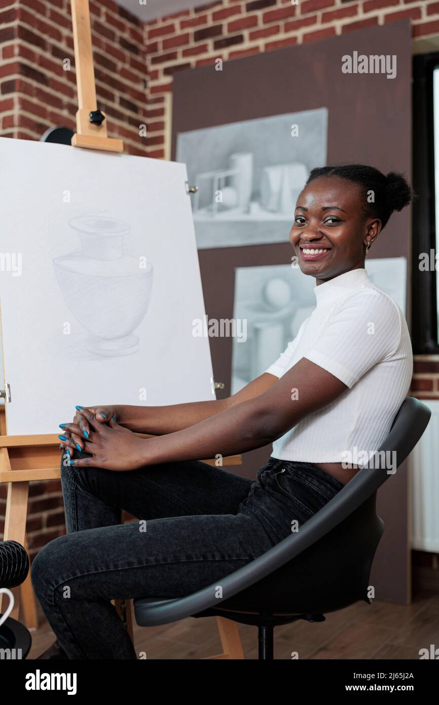 Portrait of african american student attenting art class enjoying draw ...