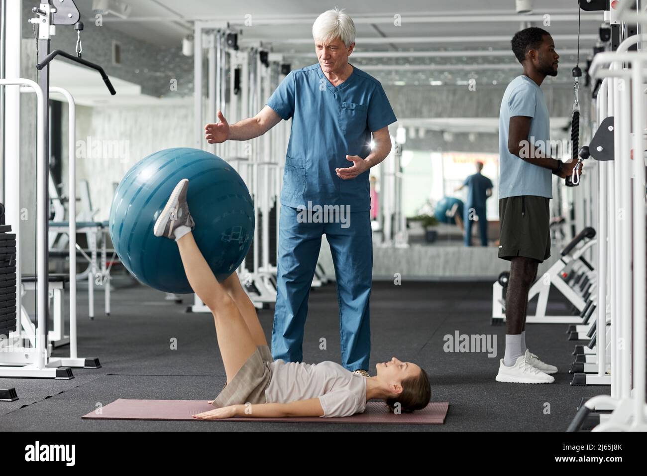 Full length portrait of young woman doing rehabilitation exercises on ...