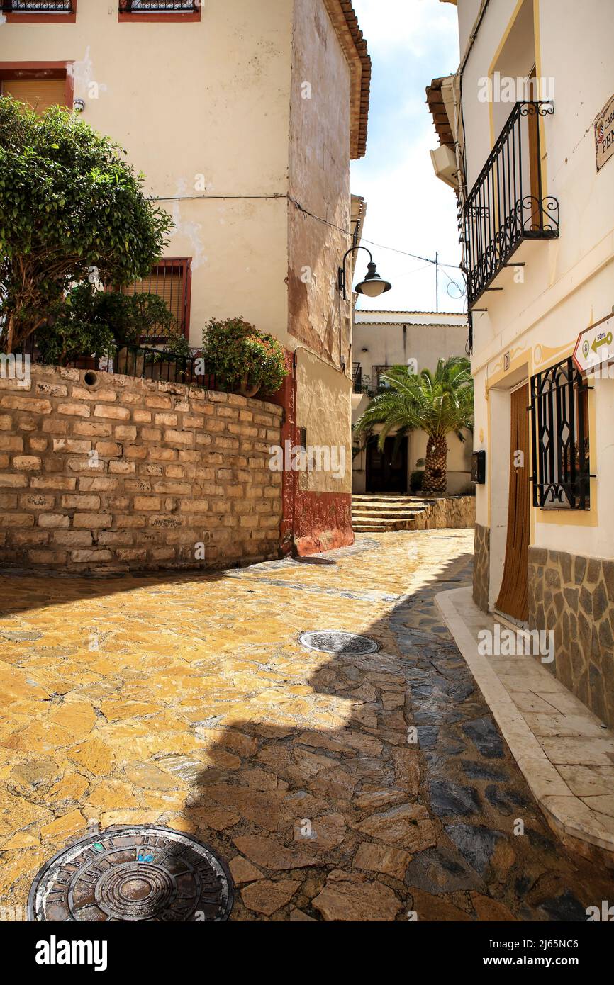 Finestrat, Alicante, Spain- April 23, 2022: Narrow cobbled street and ...
