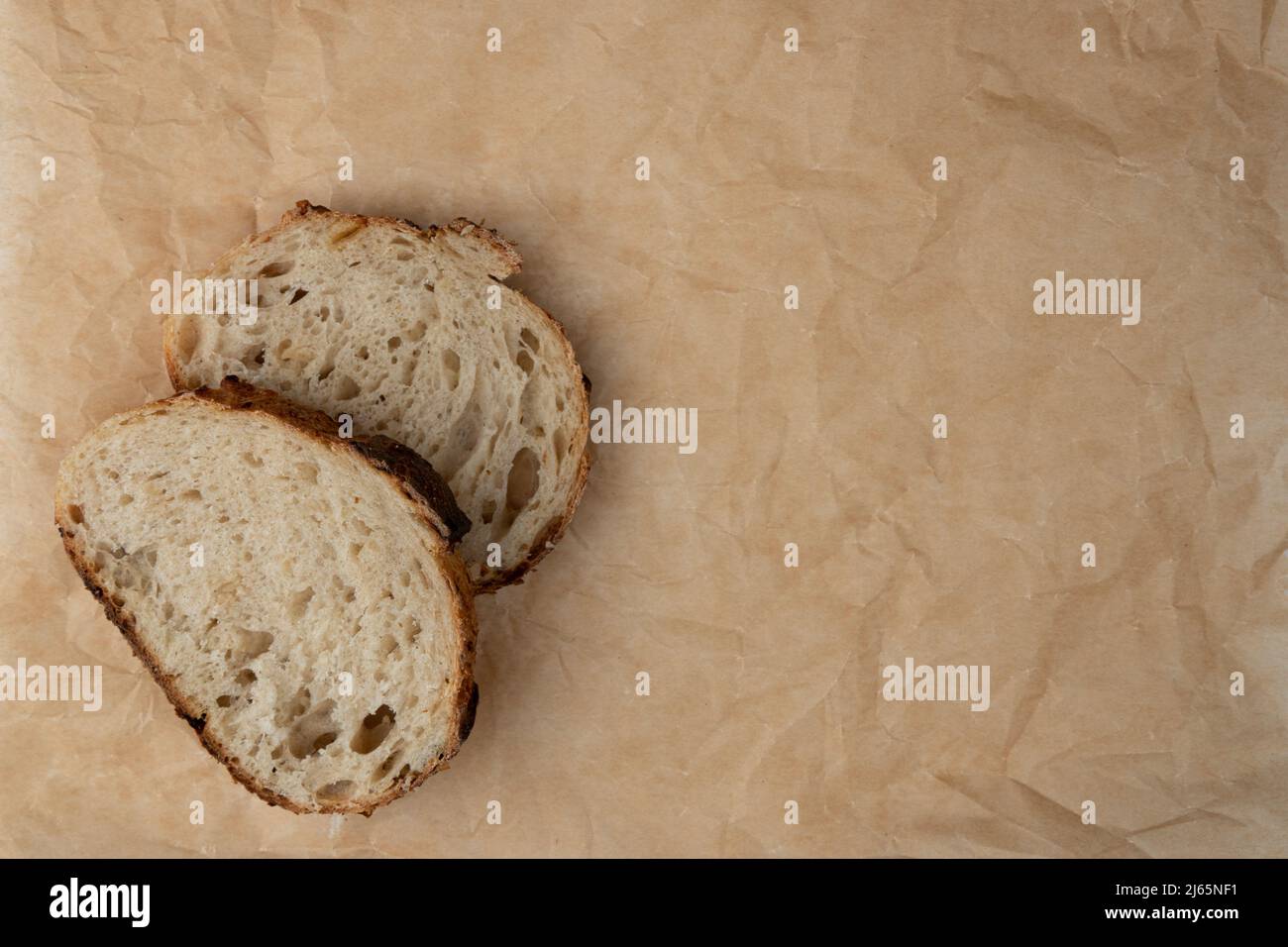 two slices wheat bread and empty space for text isolated on parchment ...