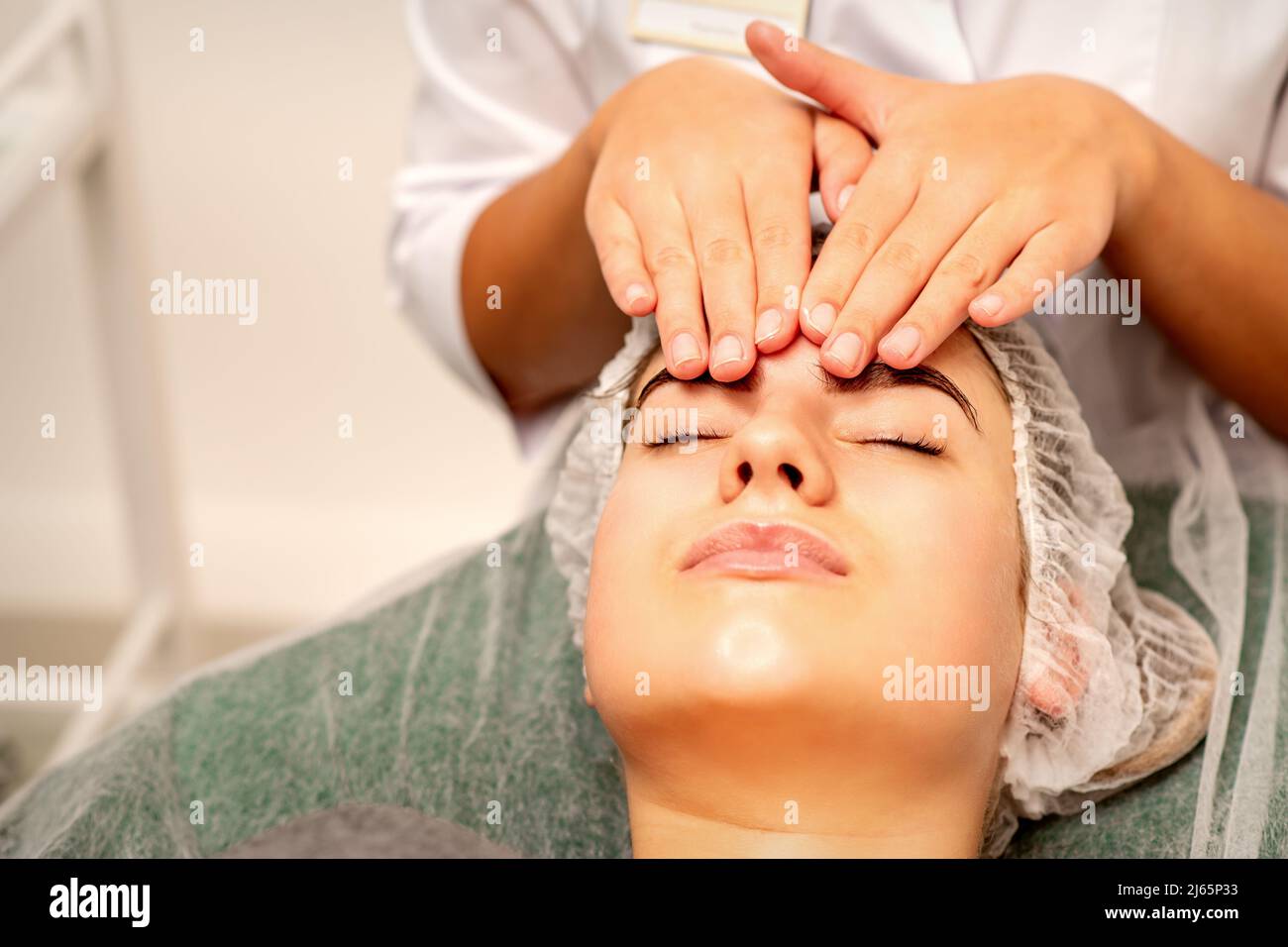 Head massage. Beautiful caucasian young white woman receiving a head ...