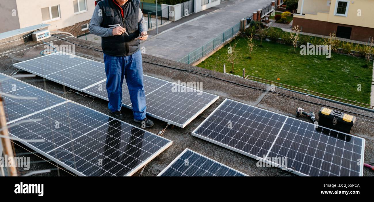Solar panel technician using tablet hi-res stock photography and images ...