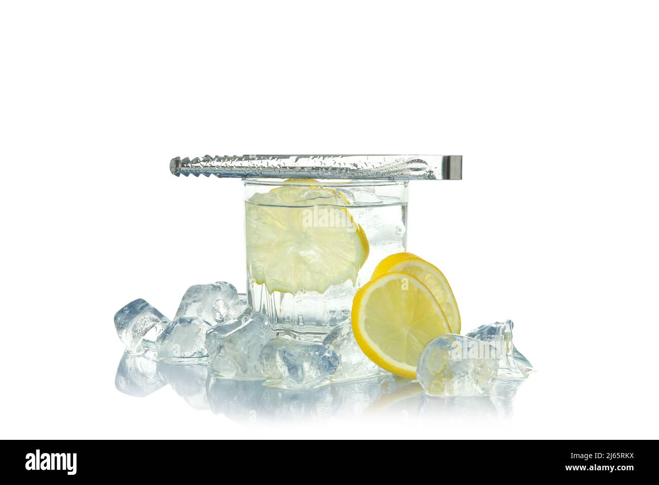 Glass of water with ice, lemon and tongs isolated on white background ...