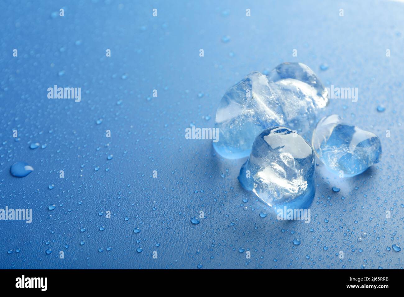 Ice forms on wet blue background, space for text Stock Photo - Alamy