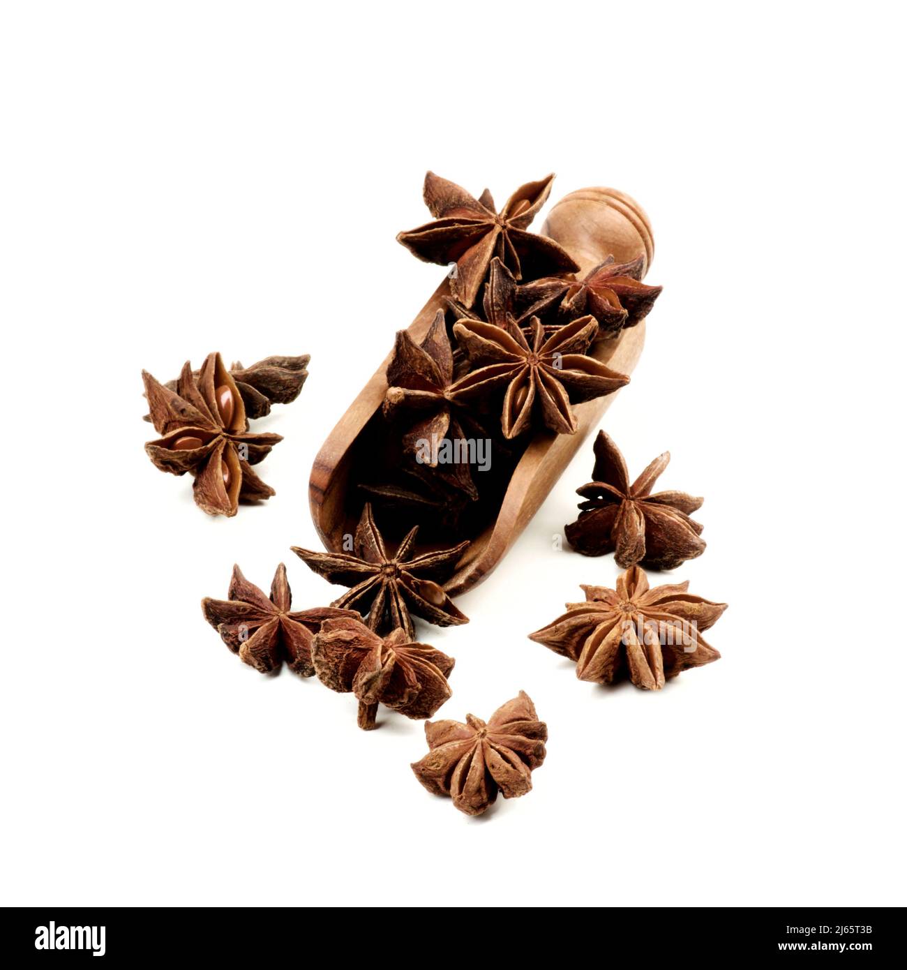 Spicy Dried Anise Stars in Wooden Scoop isolated on White background ...