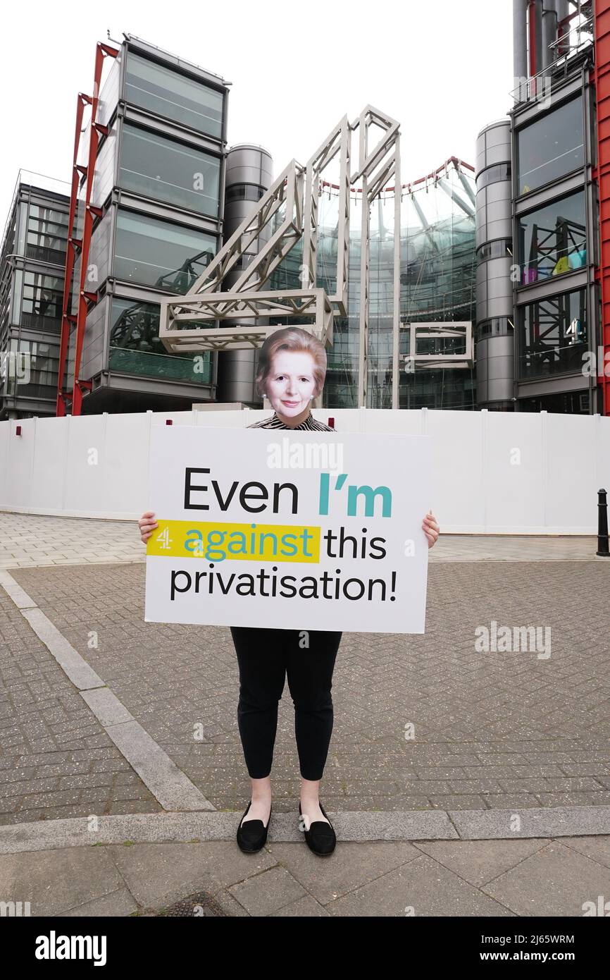 A woman wearing a mask of former prime minister Margaret Thatcher holds ...