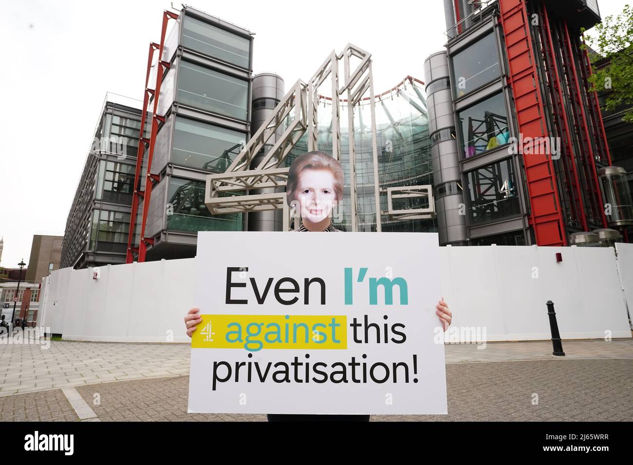 A woman wearing a mask of former prime minister Margaret Thatcher holds ...