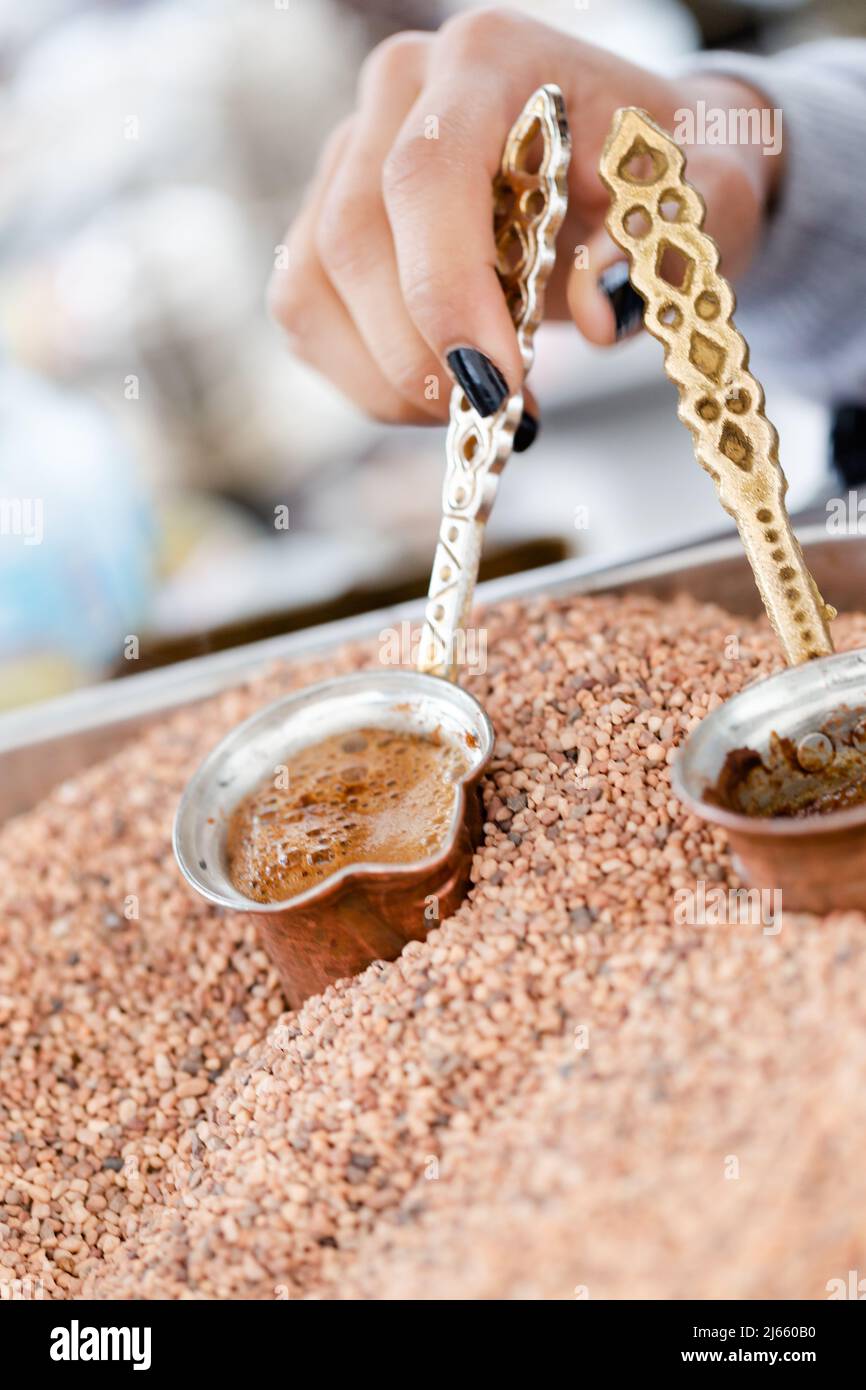 Traditional Turkish, Arabic coffee is brewed in small copper cups in ...