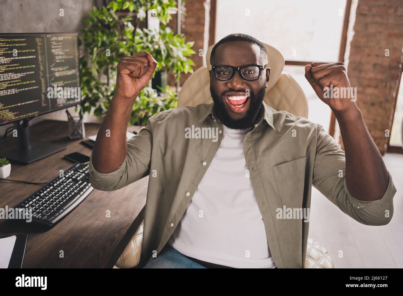 Portrait of attractive cheerful skilled lucky guy expert rejoicing ...