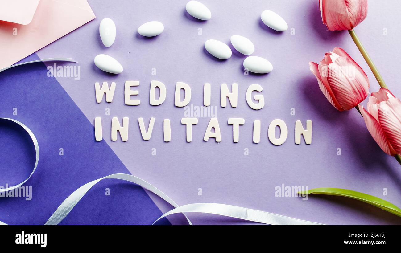 Wedding invitation letter text on purple background Stock Photo - Alamy