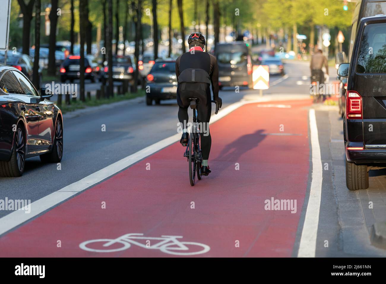 racing cyclists on red bike lane Stock Photo - Alamy