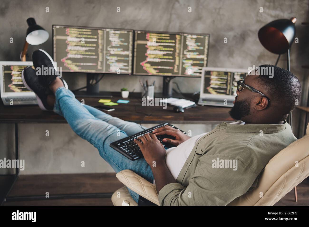Profile side view portrait of attractive focused skilled guy expert technician editing code at ...