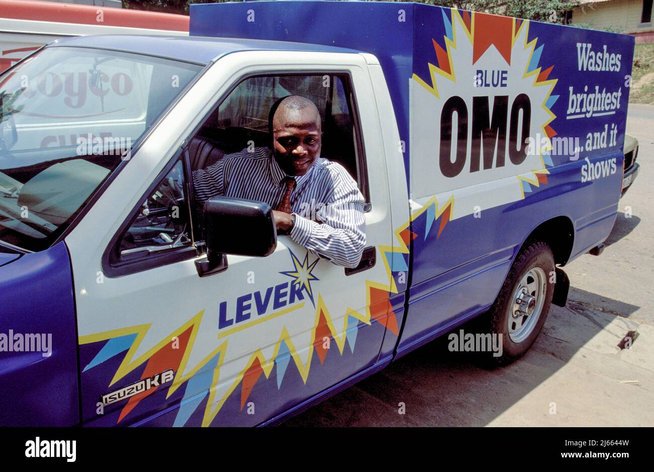 Ghana, Accra; man posing in omo advertisement car Stock Photo - Alamy