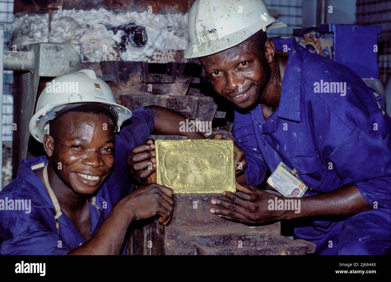 Ghana, Kumasi region; workers showing piece of gold from gold mine ...