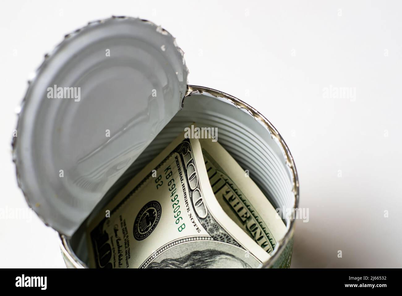 Dollars in an open tin can. Safeguarding cash, stash concept. Time to ...