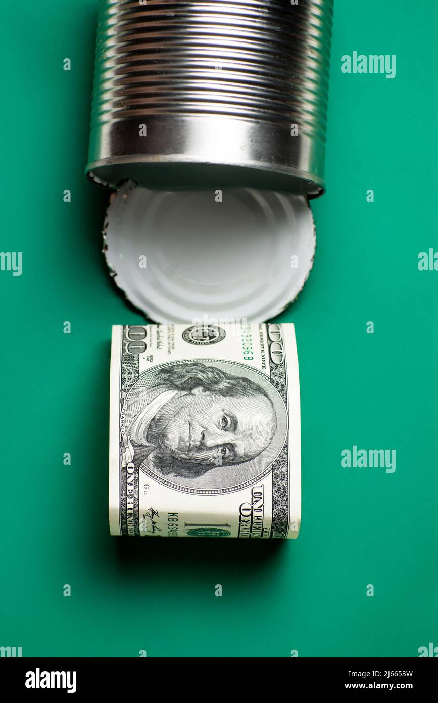 Dollars in an open tin can. Safeguarding cash, stash concept. Time to ...