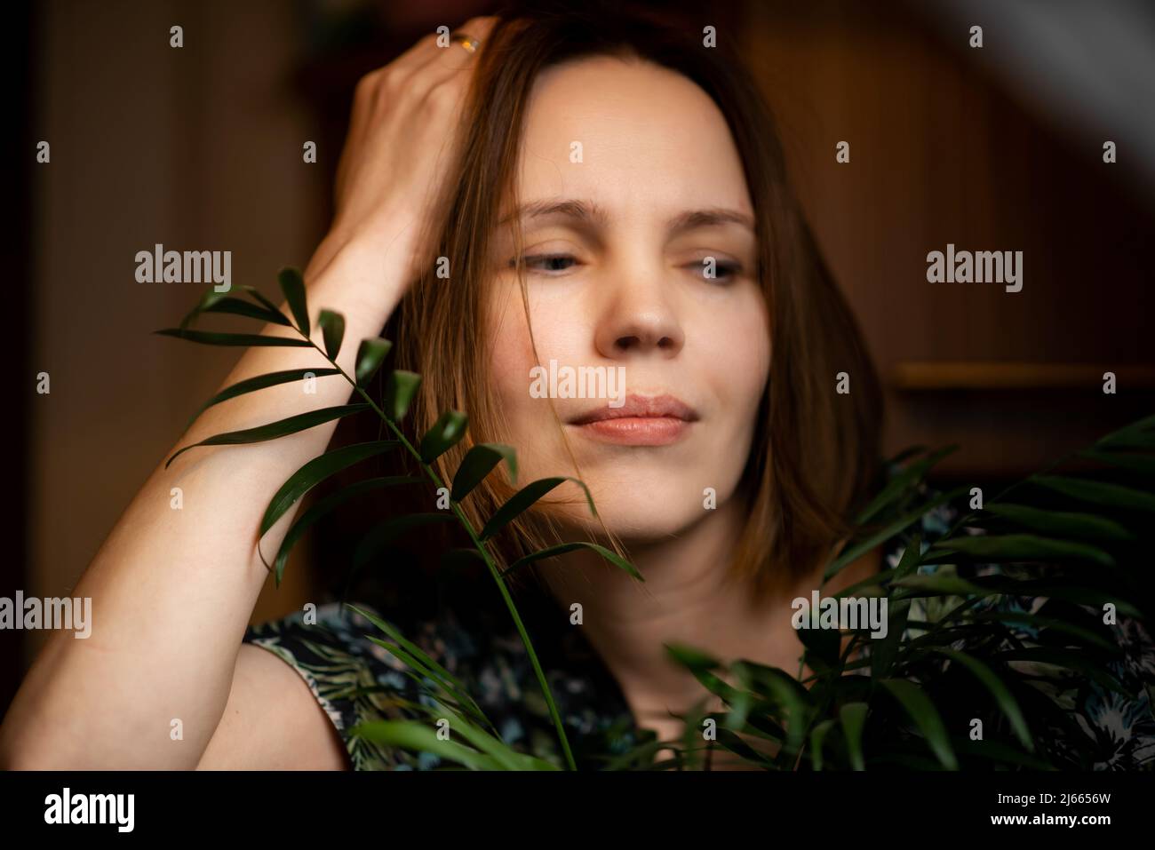 Woman relaxing at home in plants. an attractive woman of forty years of ...