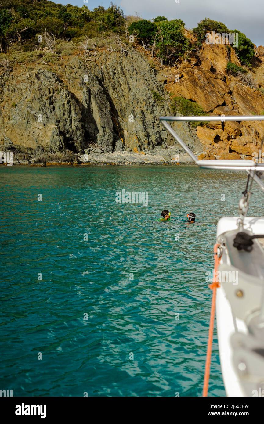 swimming below an island cliff Stock Photo - Alamy