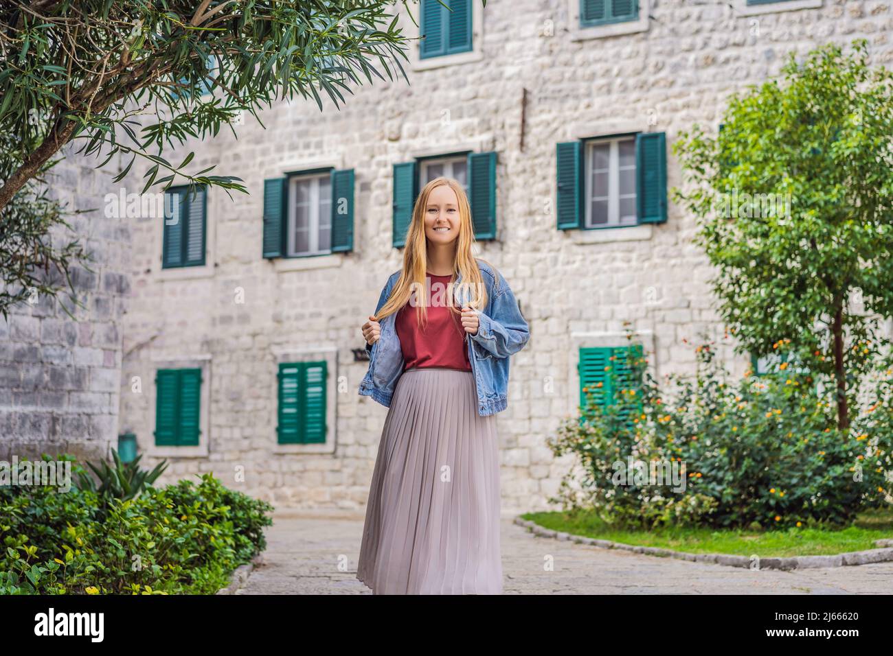 Woman tourist enjoying Colorful street in Old town of Kotor on a sunny ...