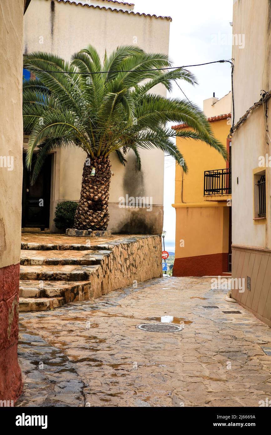 Finestrat, Alicante, Spain- April 23, 2022: Narrow cobbled street and ...