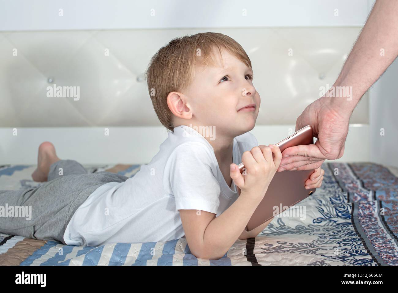 Kids and gadgets. The child does not want to give the tablet to his ...