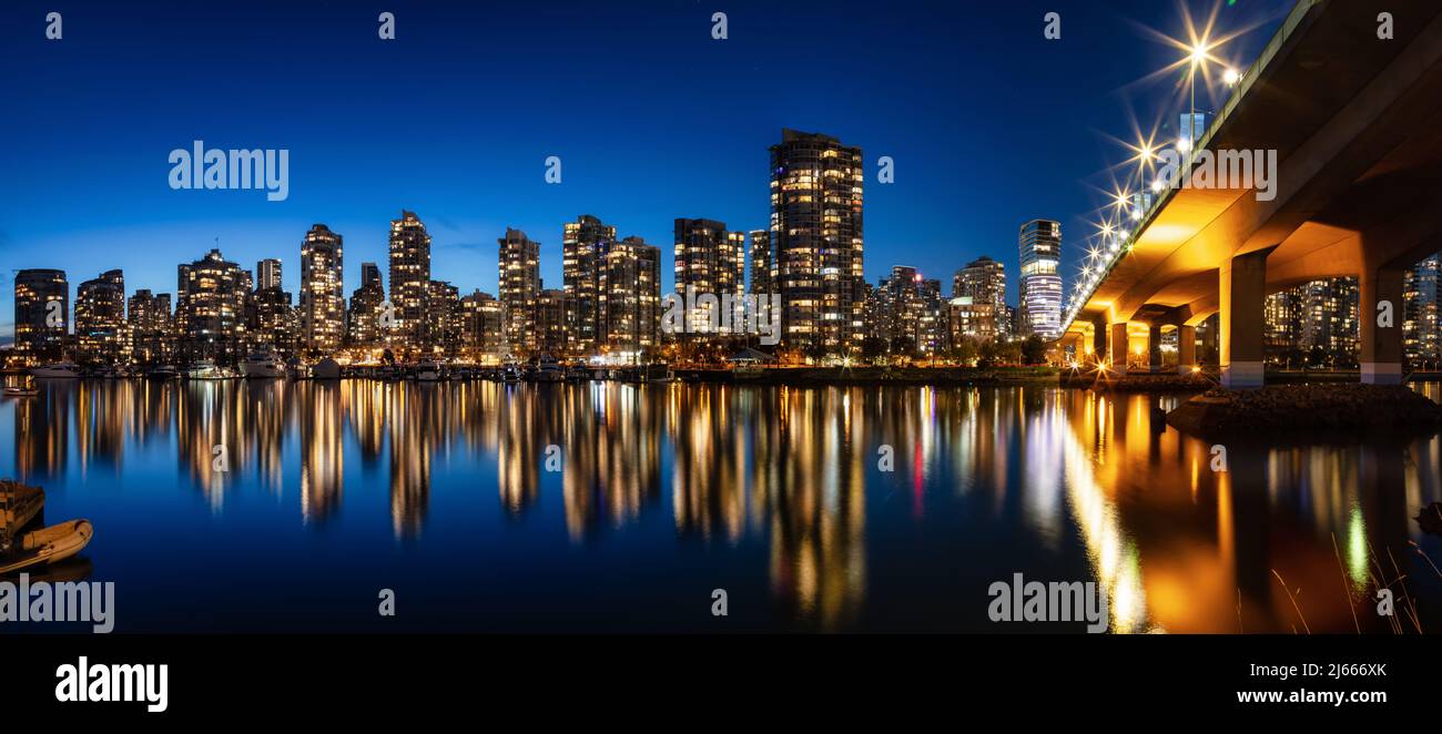Cambie Bridge in False Creek with modern city buildings at night after ...