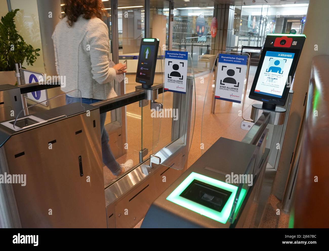 Hamburg, Germany. 28th Apr, 2022. A woman walks past the biometric ...