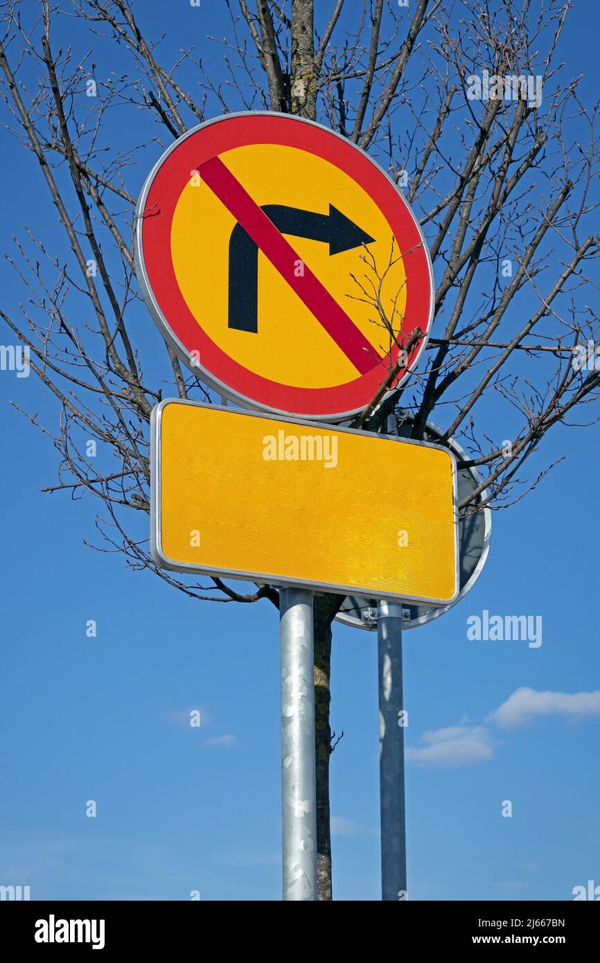 Arrow traffic sign outside on urban street with blue sky background ...