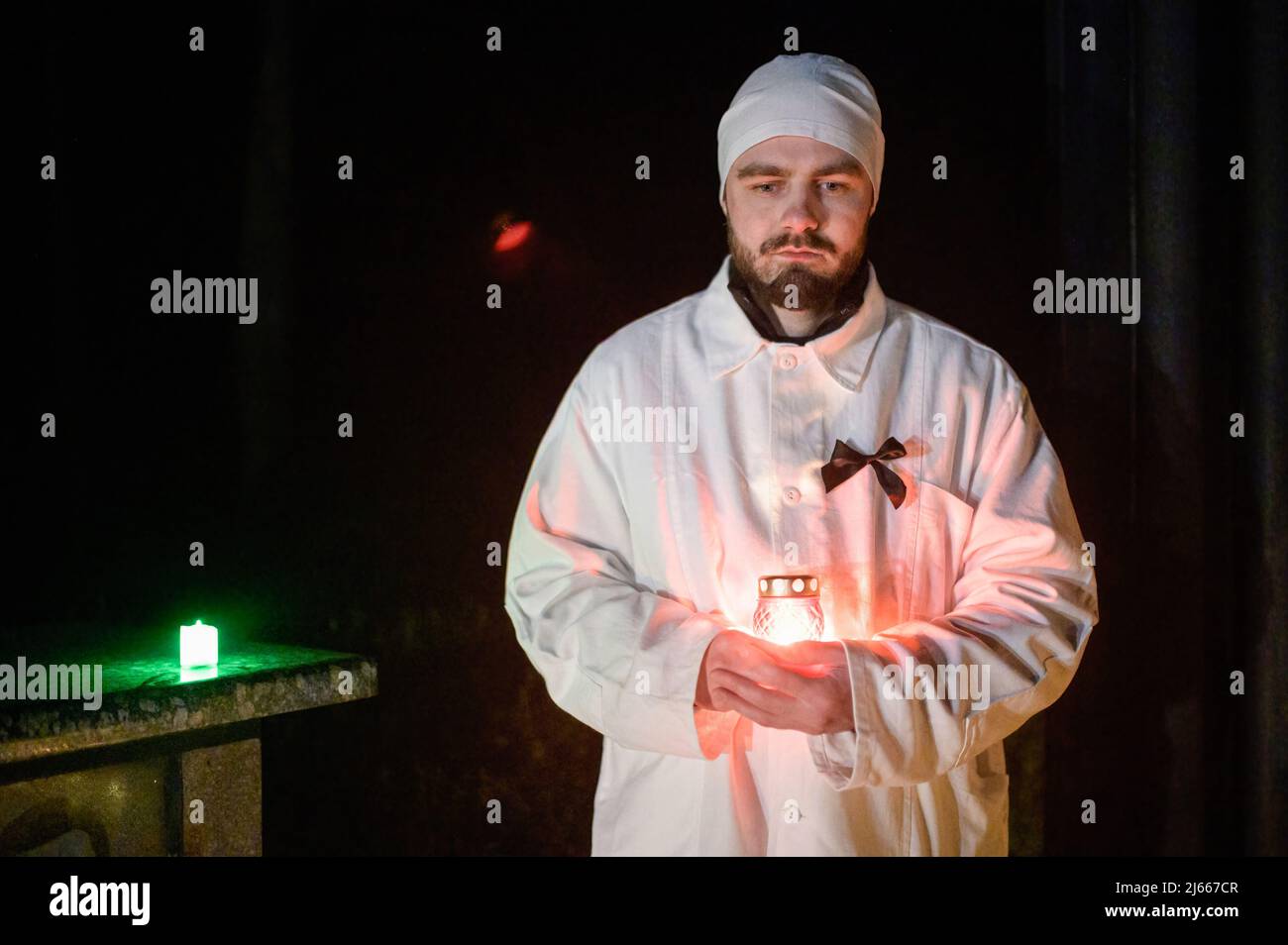 A performer seen holding a candle at the site of the Monument for the ...