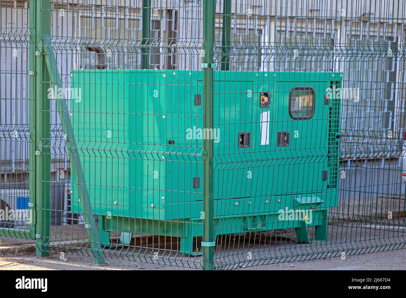 Emergency electric power generator outdoors in metal cage Stock Photo ...
