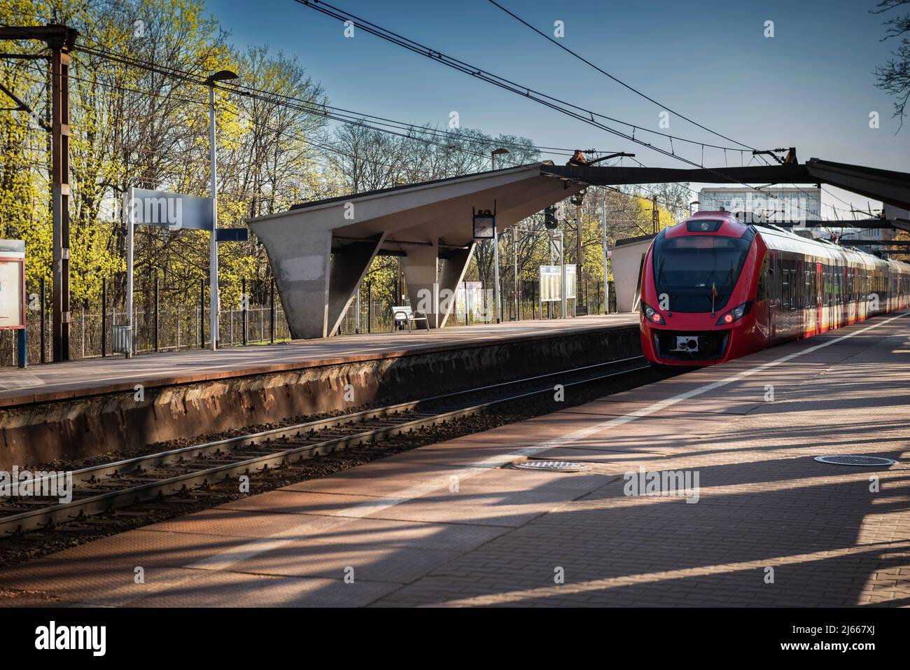 The modern train arrives at the platform at the train station Stock ...