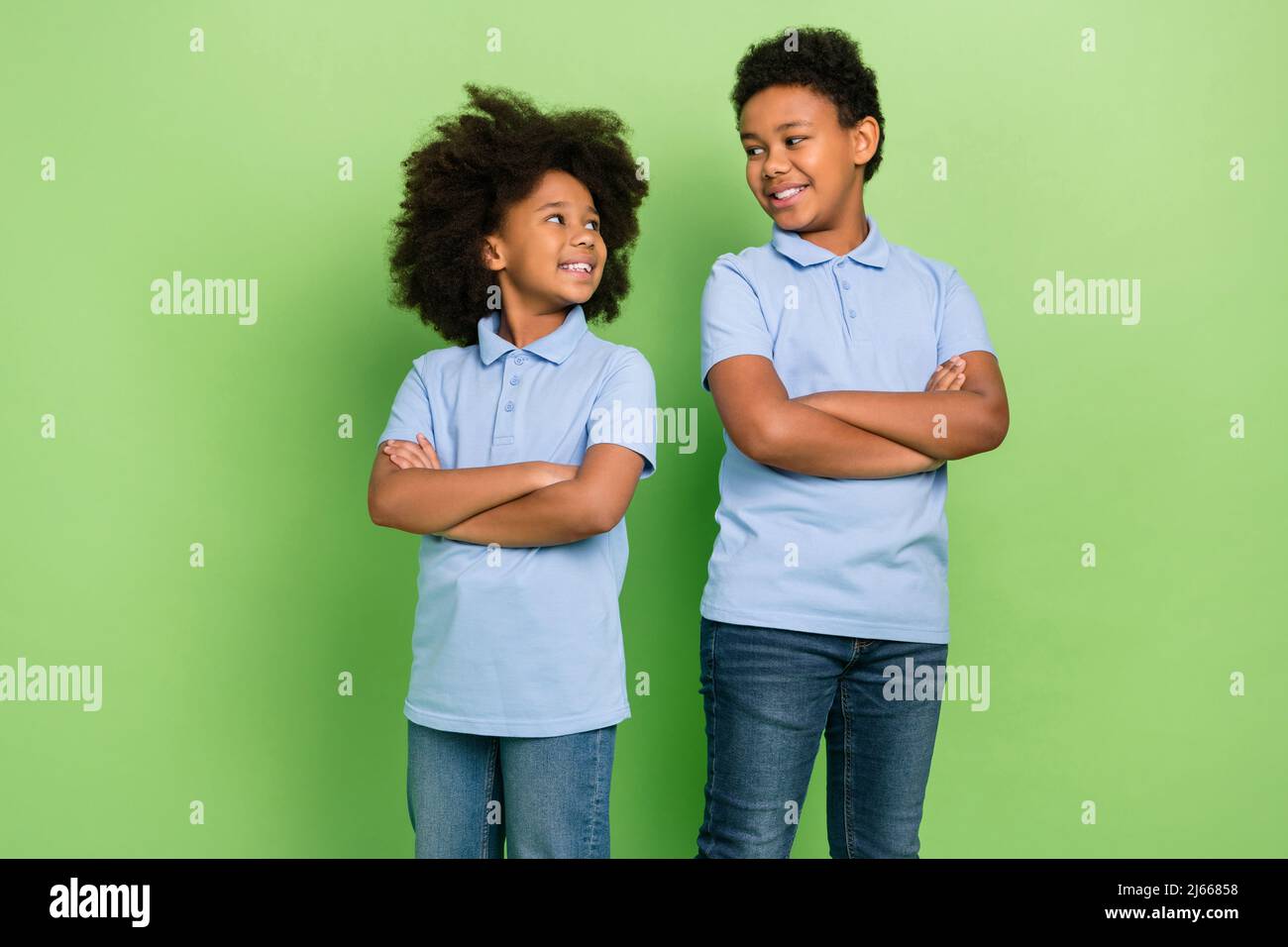 Portrait of beautiful handsome cheerful pre-teen kids folded arms ...