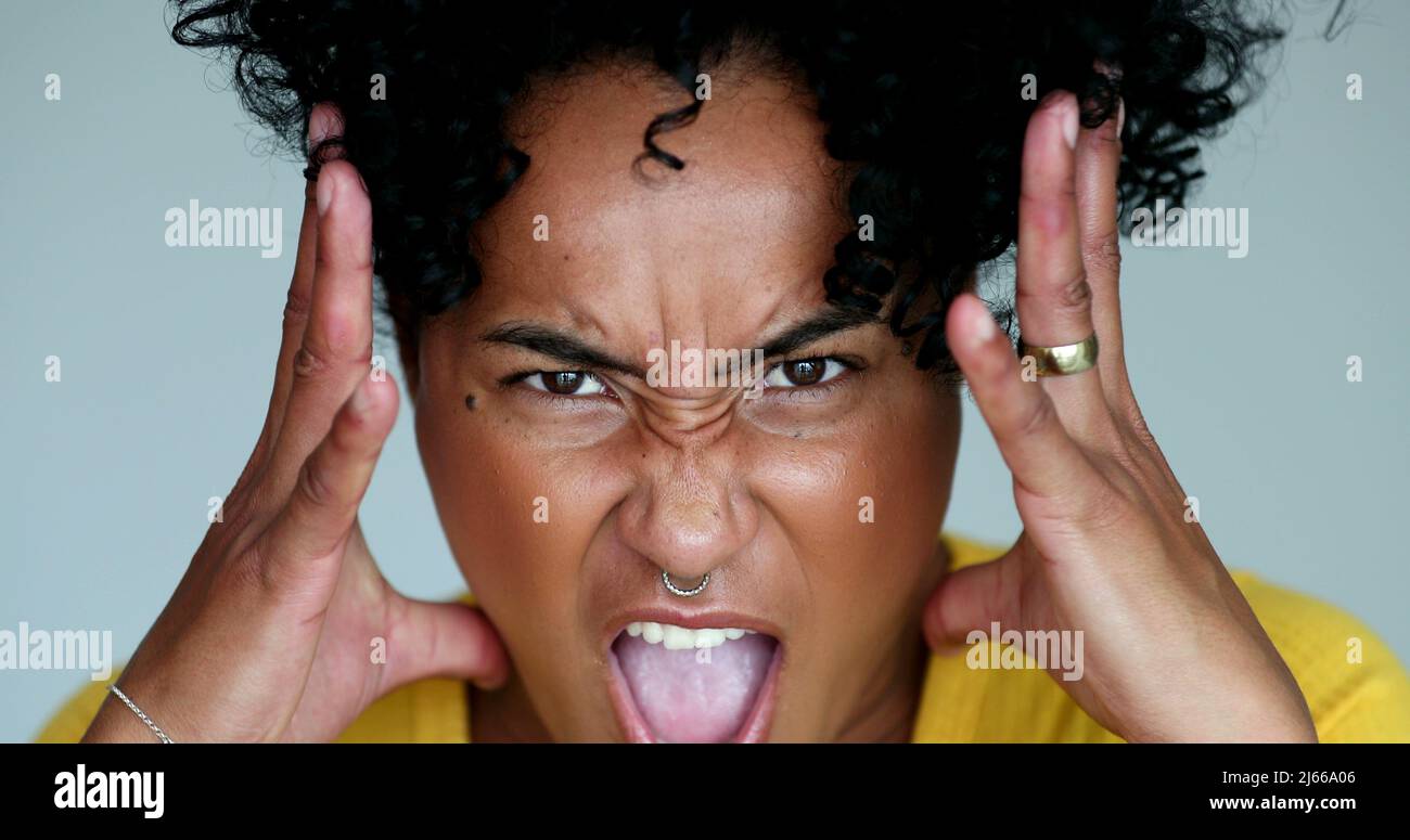 Close-up black woman face yelling at camera Stock Photo - Alamy
