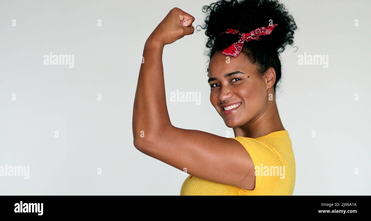 Confident black African woman doing symbolic feminist muscle pose Stock ...