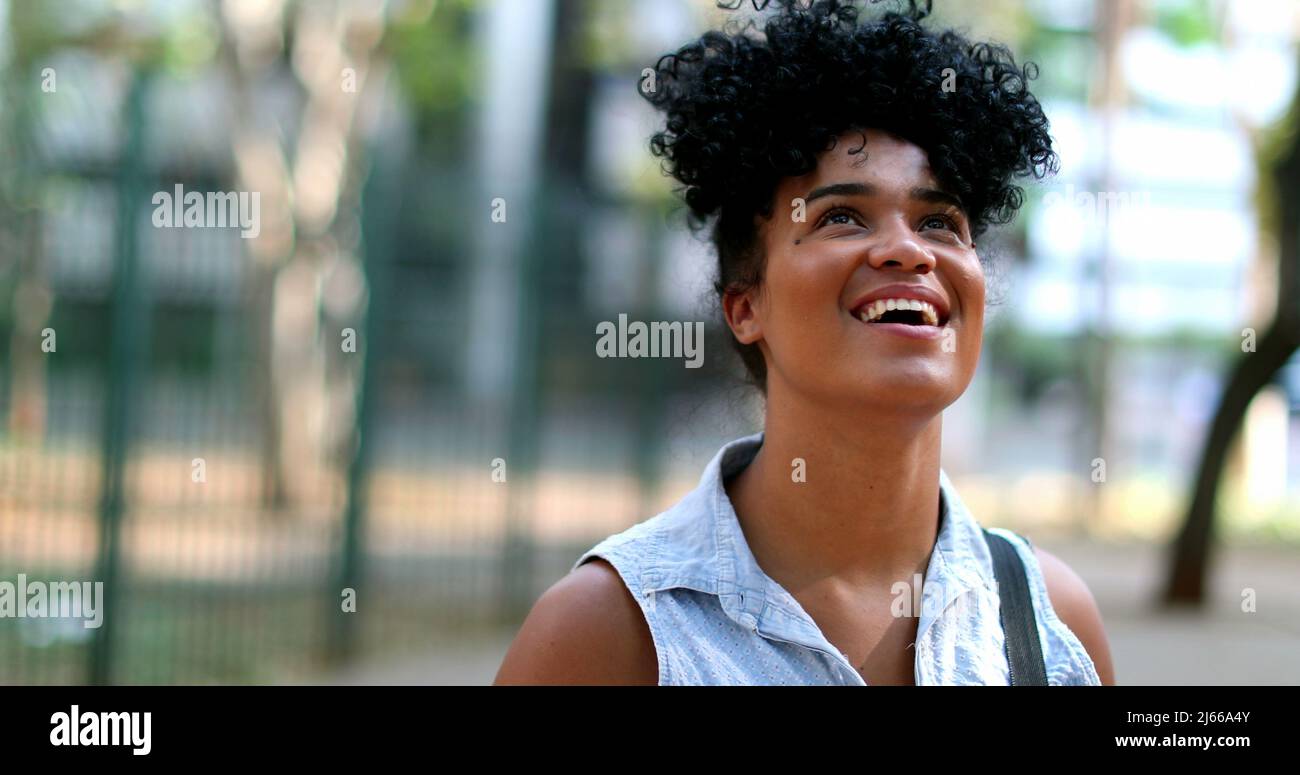Mixed race young woman standing outside smiling Stock Photo - Alamy
