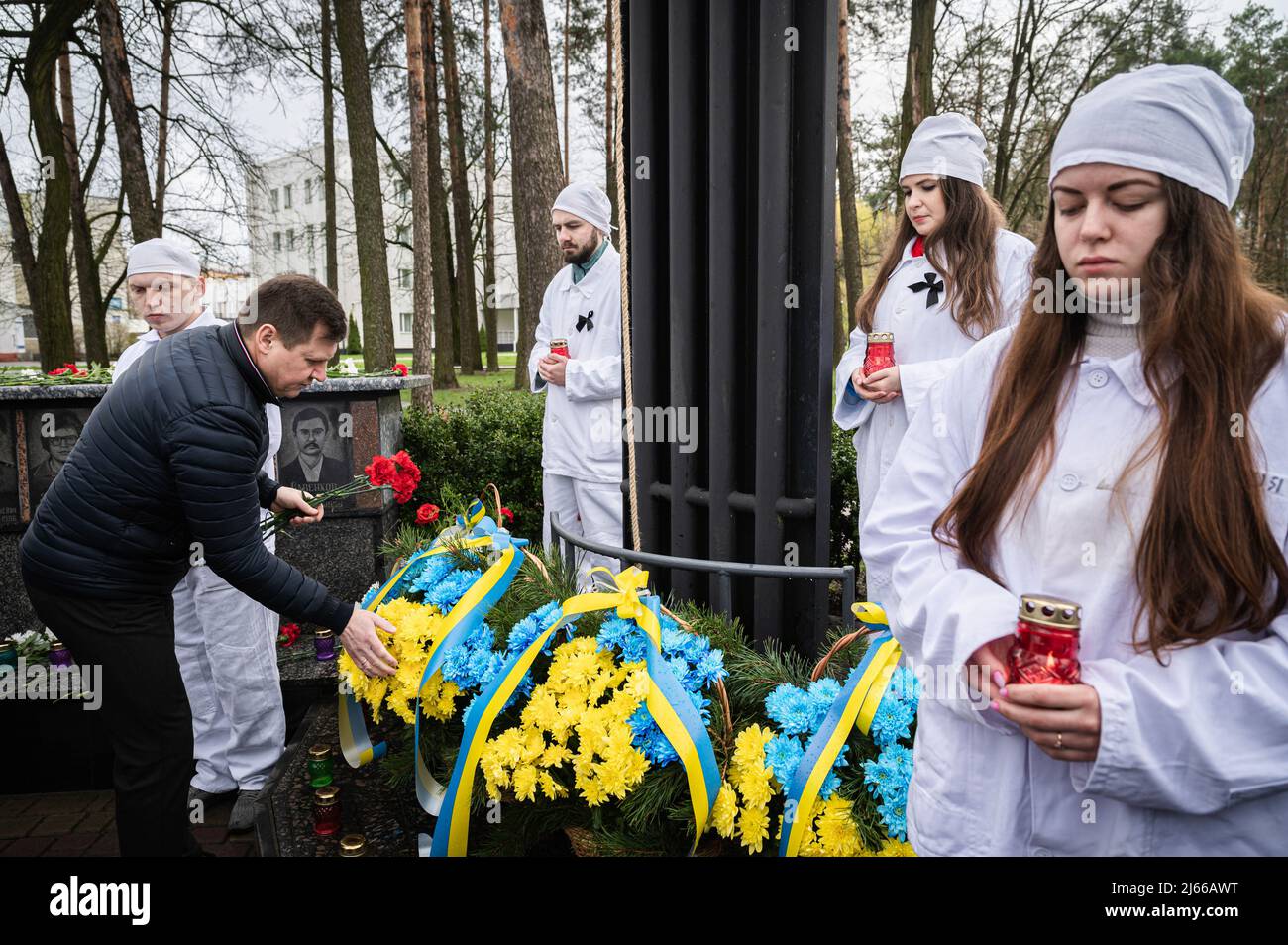 A man seen placing a basket with flowers in respect for the deceased ...