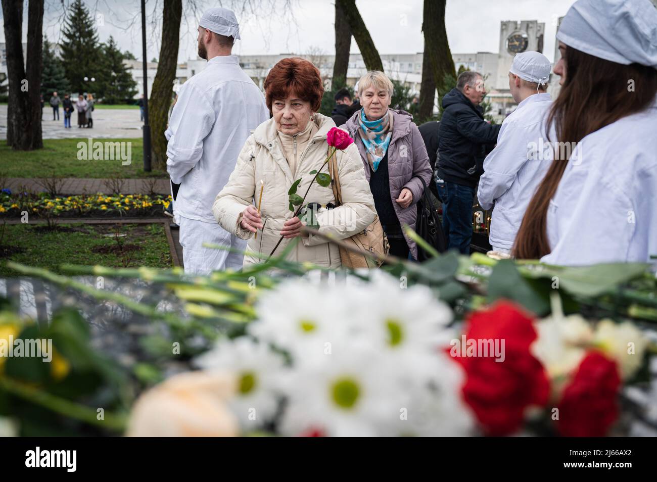 Slavutych, Ukraine. 26th Apr, 2022. A woman seen holds a candle and a ...
