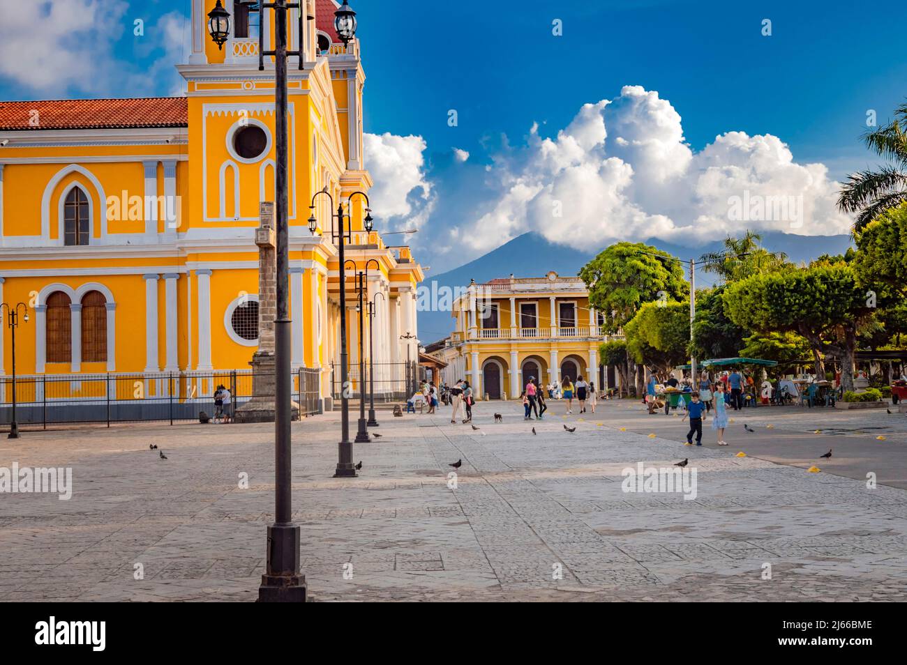 Beautiful plaza with people around in a sunset, plaza with a church ...