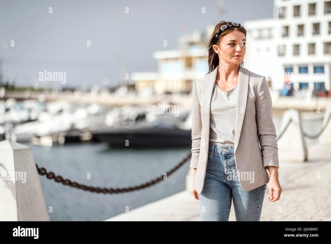 A portrait of a young confident woman walking in the city by marina ...